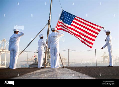 Us Navy Sailors Raise The American Flag During Morning Colors Aboard