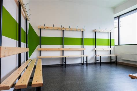 Premium Photo Modern Locker Room With Vibrant Green And White Striped Walls Wooden Benches And