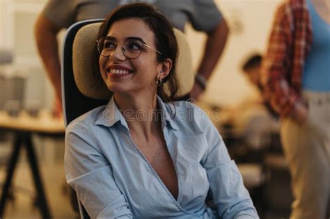 Smiling Professional Woman In Glasses Enjoying A Light Moment At Work