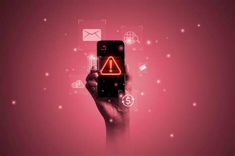premium photo hand holding smartphone with triangle caution warning