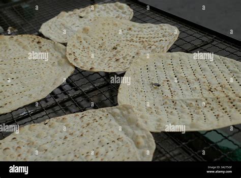 Thin Flatbreads With Perforated Patterns Baking On A Metal Rack