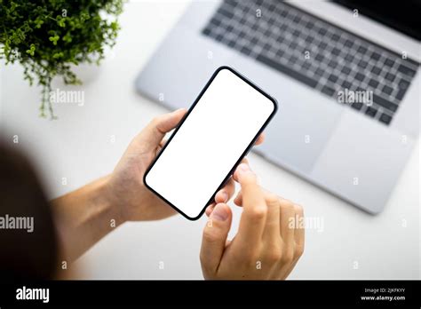 Man Using Smartphone Blank Screen Frameless Modern Top View Laptop Keyboard In Background