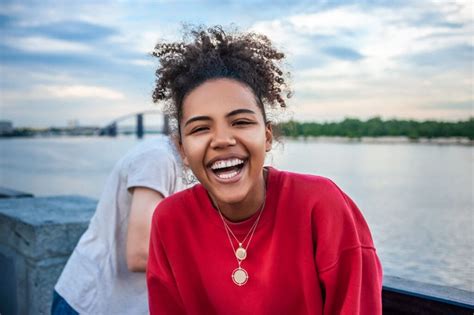 Beautiful Happy Young African American Woman Laughing At Riverbank