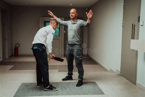 Security Guard Making Body Searching Procedure On Man For Finding Hidden Objects Before Entering