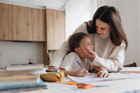 Premium Photo A Mother Helps Her Young Daughter With Homework Both