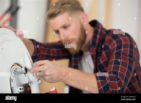Professional Electrician Man Is Fixing A Water Heater Stock Photo Alamy