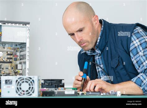 Man Fixing A Microchip Stock Photo Alamy