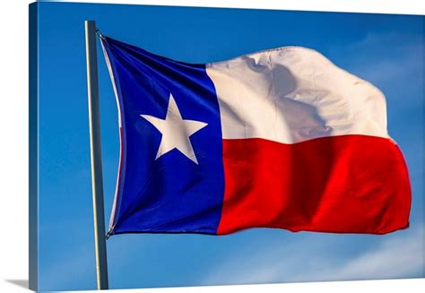 Texas Lone Star Flag Stands Out Against A Cloudless Blue Sky Houston