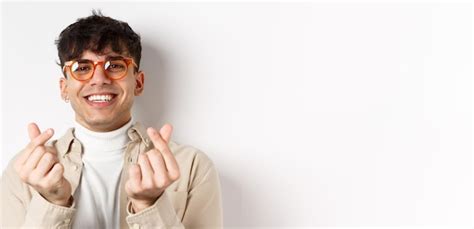 Free Photo Cute Young Guy In Glasses Smiling And Showing Finger