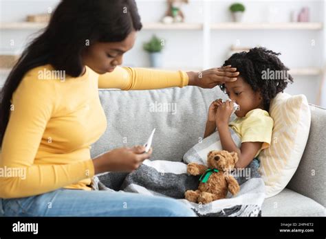 Flu Concept African American Mother Taking Care About Sick Daughter At