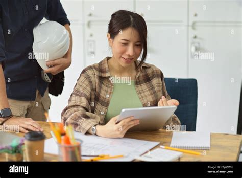 Architecture Team Meeting In Construction Site Office Female Architect Holding Digital Tablet