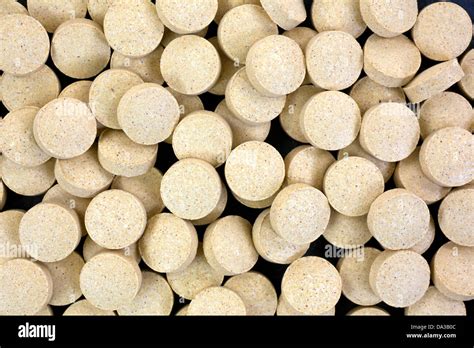 Several Selenium Mineral Supplement Tablets Grouped Atop A Black