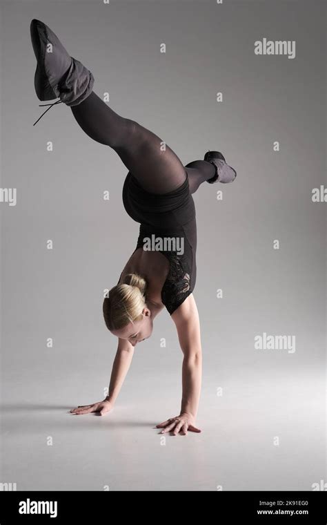 Ballet Dancer Woman Black Dress On Gray Background Ballerina Posing And Showing Her Flexibility