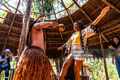 Indigenous People From The Wassú Tribe And Tourists Performing
