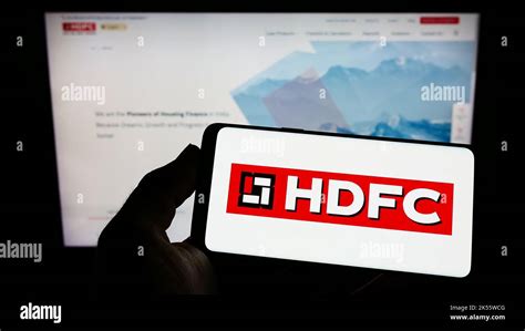 Person Holding Smartphone With Logo Of Housing Development Finance Corporation Hdfc On Screen