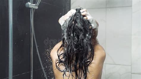 Young Brunette Woman Showering And Washing Hair In The Bathroom Stock