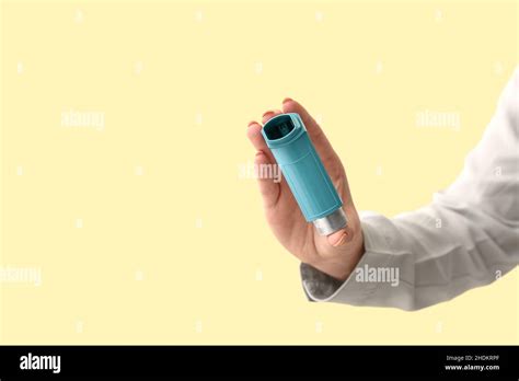 Woman Holding Asthma Inhaler On Beige Background Stock Photo Alamy