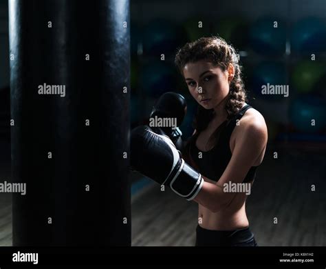 Young Fighter Boxer Girl Wearing Boxing Gloves In Training With Heavy