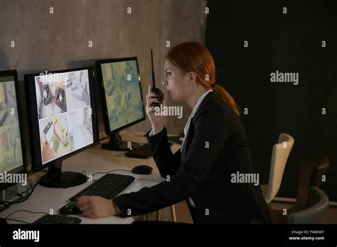 Female Security Guard Using Radio Transmitter In Surveillance Room Stock Photo Alamy