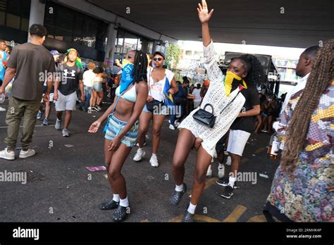 Girls Wearing Jamaica And St Lucia Face Masks Dance Ahead Of A Music