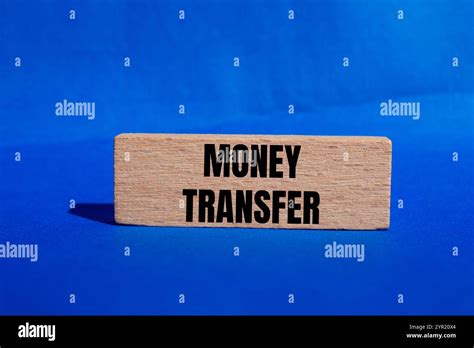 money transfer message written on wooden block with blue background