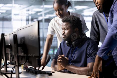 Team of data center employees working together to create technical documentation for software ...