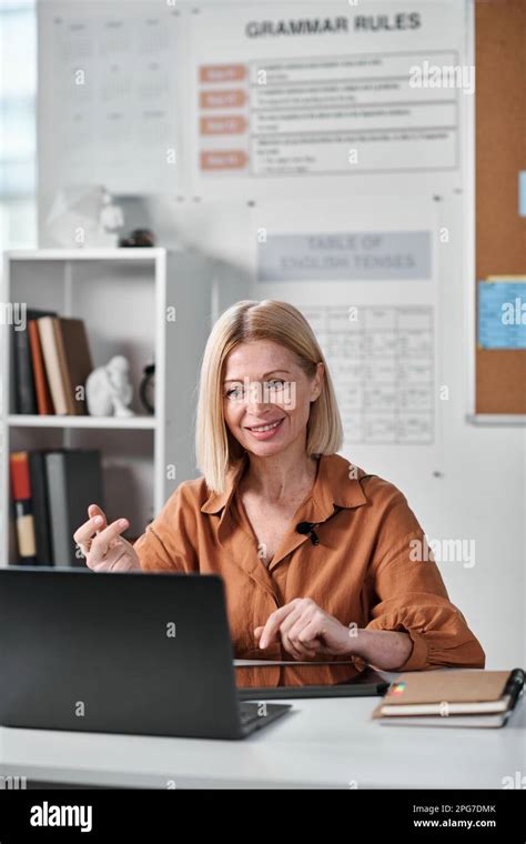 Vertical Image Of Teacher Having Online Lesson With Students While