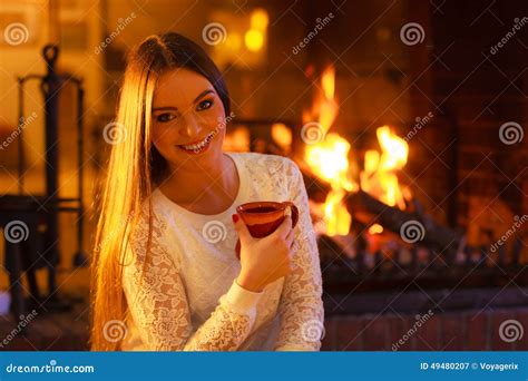 Girl Warming Up At Fireplace Holds Mug Stock Image Image Of Flame