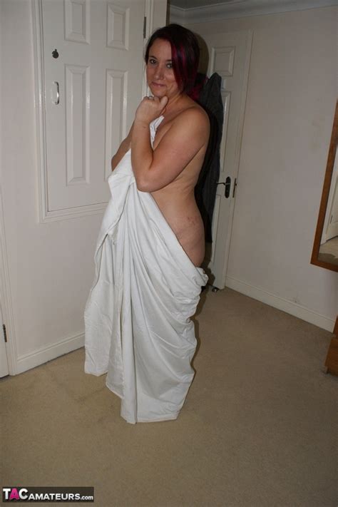 Overweight Redhead Models Completely Naked While In Her Bedroom