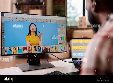 african american editor using retouching software to edit photo