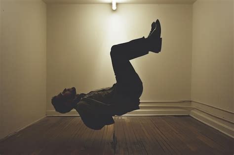Premium Photo A Man Is Balancing On His Hands With His Legs In The