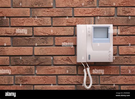 Modern Intercom System With Handset On Red Brick Wall Space For Text