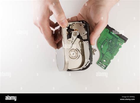 The Computer Hard Drive In The Course Of Dismantling On A White Background Stock Photo Alamy