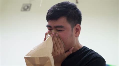 Young Man Hyperventilating And Breathing In Paper Bag 동영상 1072390226