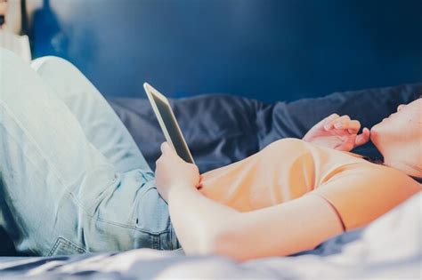 Premium Photo Low Section Of Woman Lying On Bed