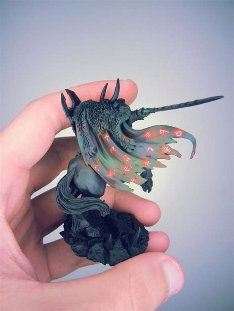 A Hand Holding A Small Toy With Lights On It