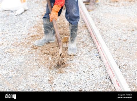 Worker Digging A Floor With A Pickaxe In Construction Site Stock Photo Alamy