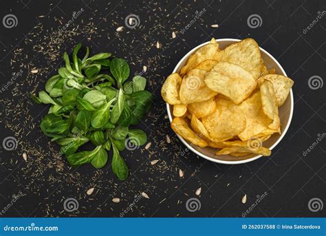 Lettuce Leaves And A Bowl Of Chips On A Black Background Healthy Food