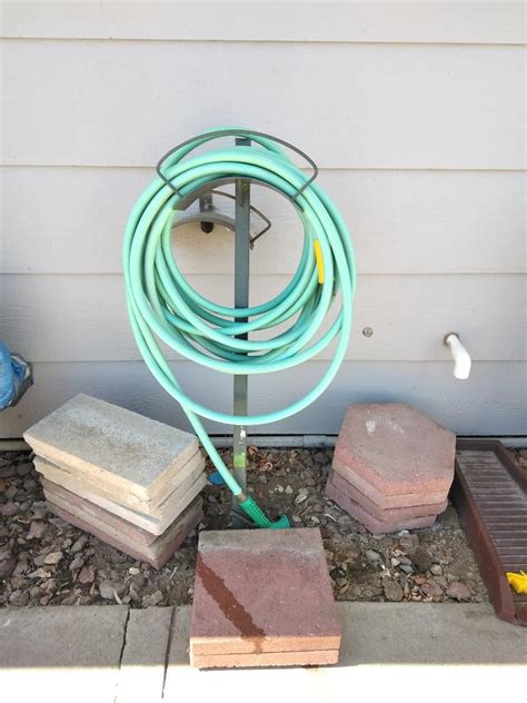 Lot 416 Garden Hose Holder And Bricks