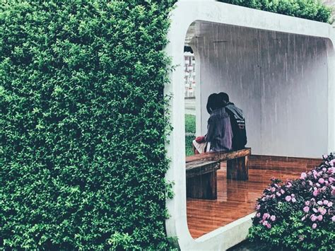 Premium Photo Couple Sitting In Built Structure During Monsoon