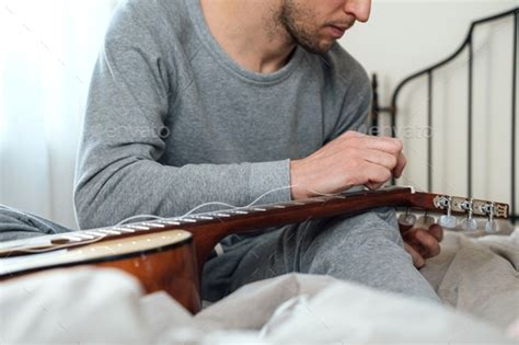 Changing Strings On Acoustic Guitar Man Changing Strings Stock Photo