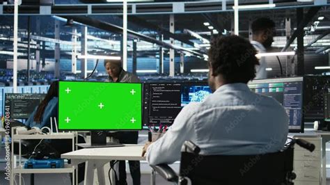 Data Center Worker With Paraplegia Using Green Screen Pc To Apply Node