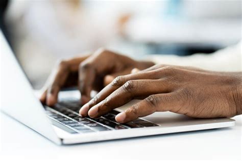 Premium Photo African American Programmer Writing Code On Laptop Keyboard At Workplace