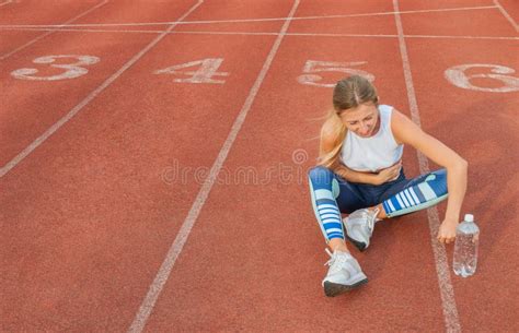 Tired Woman Runner Taking A Rest After Run Sitting On The Running Stock