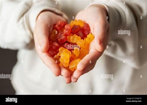 Chewable Gummy Bears Vitamins And Supplements A Girl Holds A Gummy