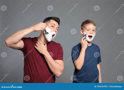 Dad Shaving And Son Imitating Him On Grey Stock Image Image Of