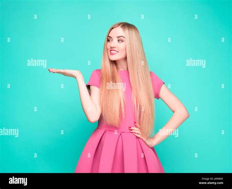 Smiling Beautiful Young Woman In Pink Mini Dress Posing Presenting