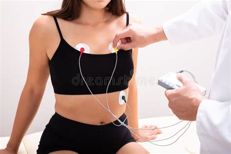 Doctor Applying Holter Heart Monitor On Woman S Body In Clinic Stock Photo Image Of Hospital