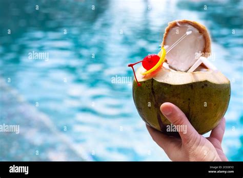 Man Holding Coconut Cocktail Stock Photo Alamy