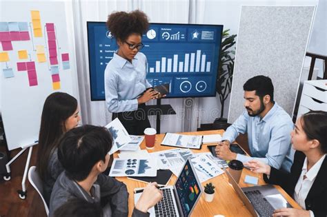 Young African Businesswoman Presenting Data Analysis Dashboard On Tv